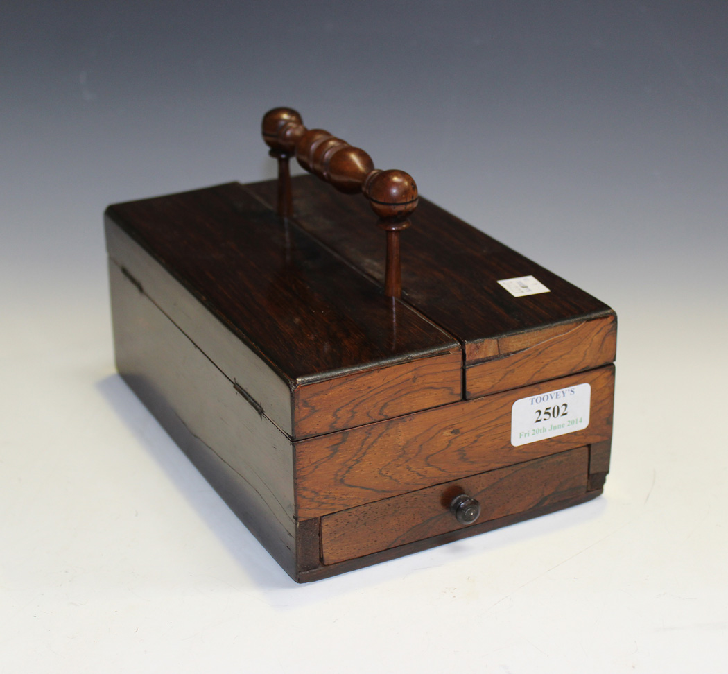 An early Victorian rosewood writing box, the twin hinged lid centred by ...