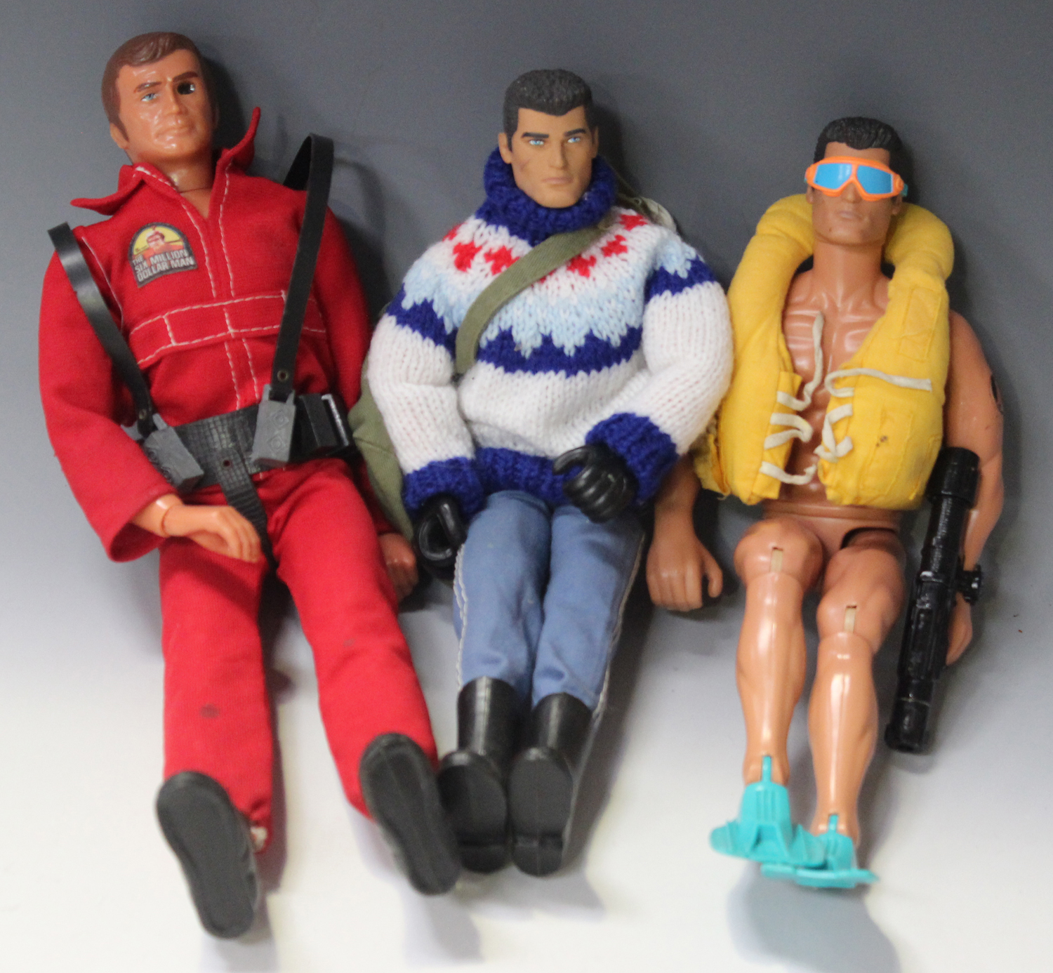 A Six Million Dollar Man Action Figure Two Other Action Figures A